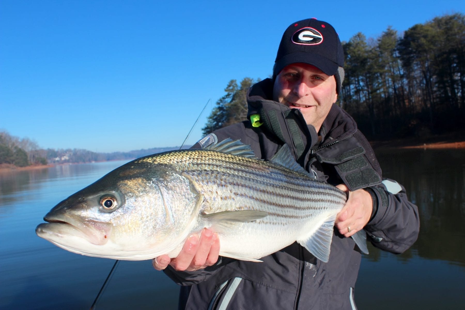 Henry Cowen with a big striper caught on his fly rod - Coastal Angler ...