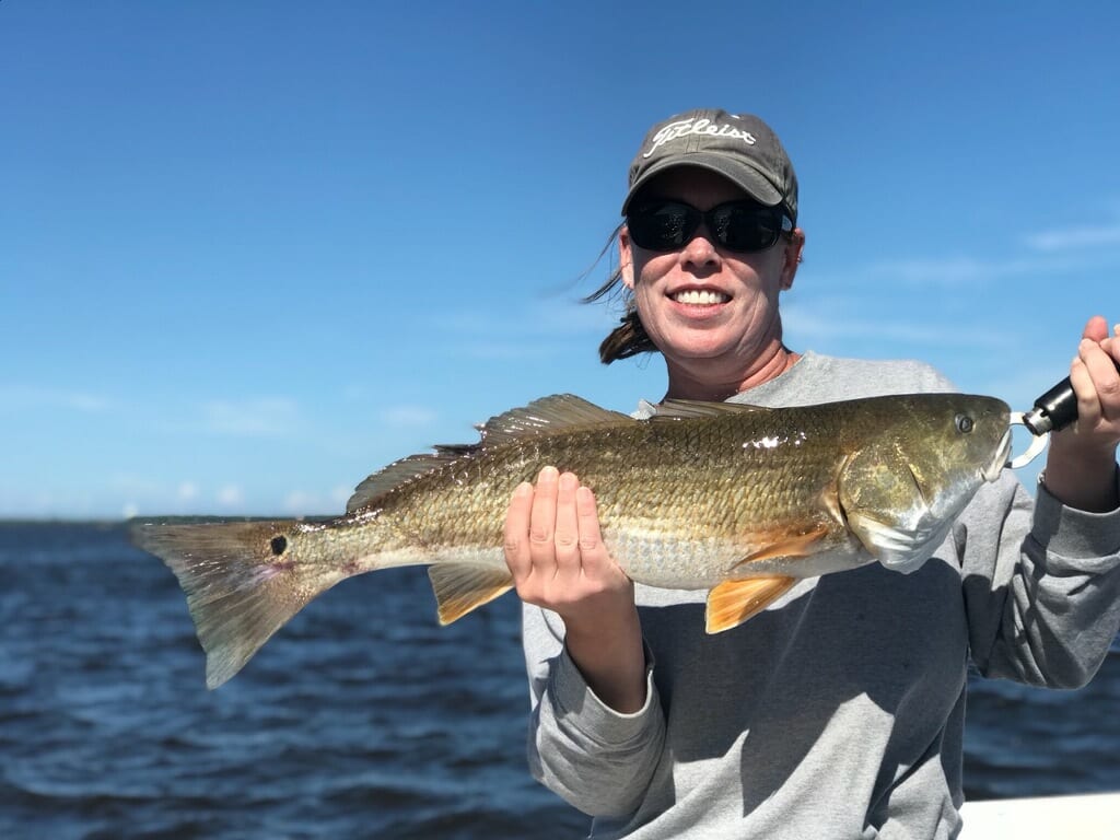 Ashley with a nice keeper redfish - Coastal Angler & The Angler Magazine