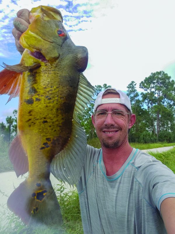 Larry Wall with a nice peacock bass. - Coastal Angler & The Angler Magazine