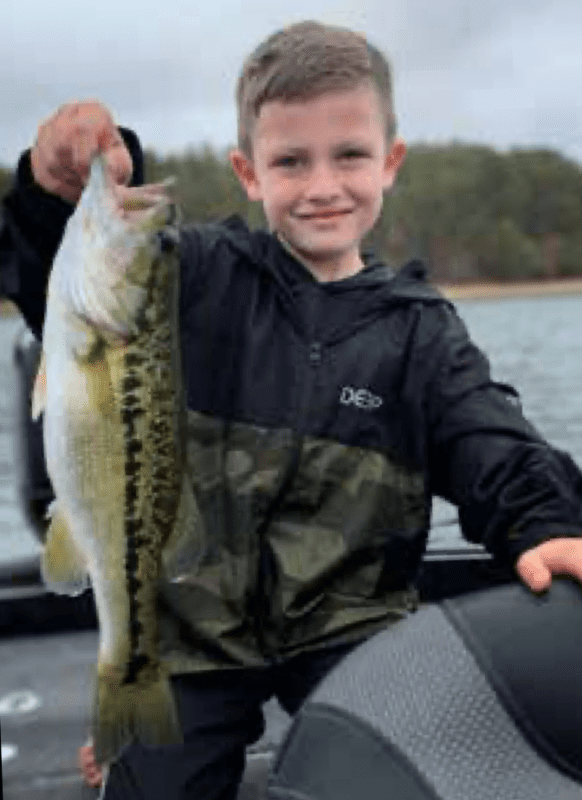 Tucker Winters with a nice spotted Bass he caught while fishing at Lake ...